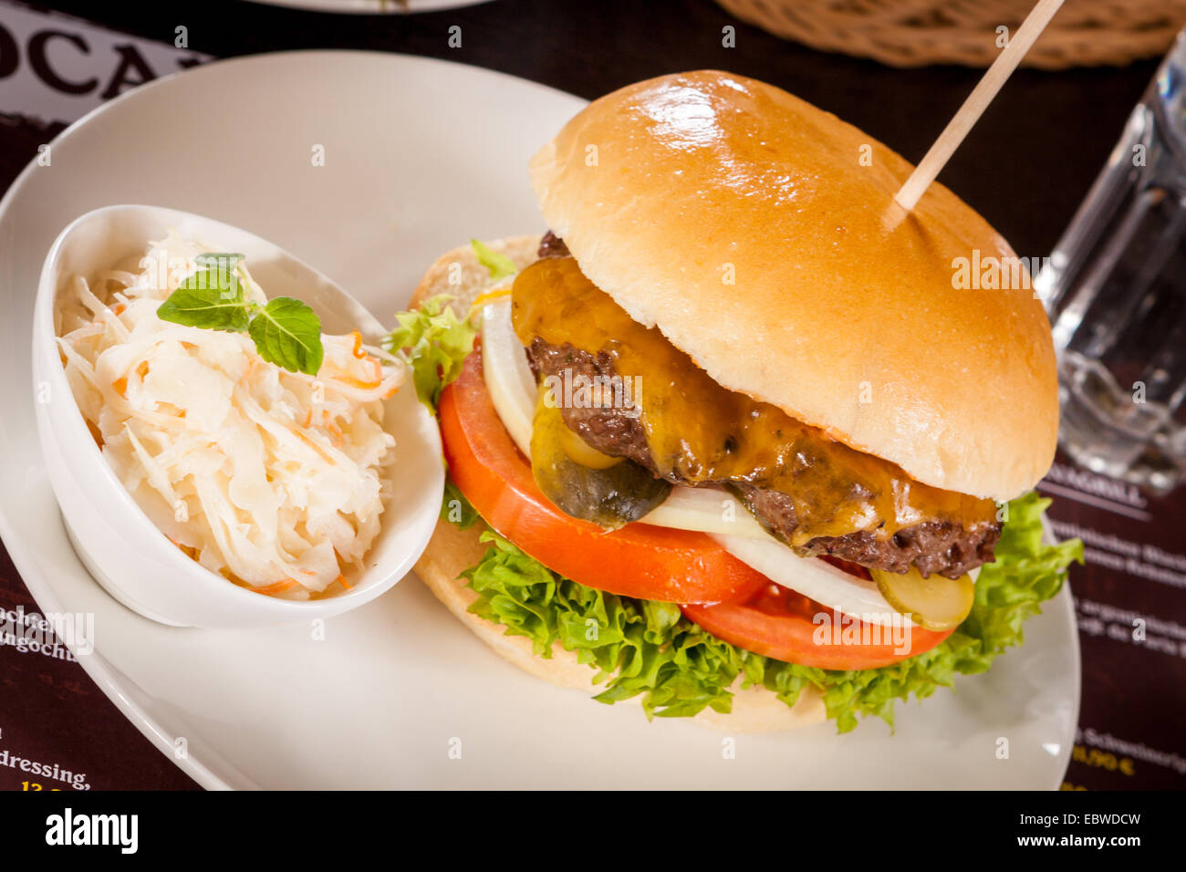 Tasty traditional cheeseburger with a ground beef patty topped with ...