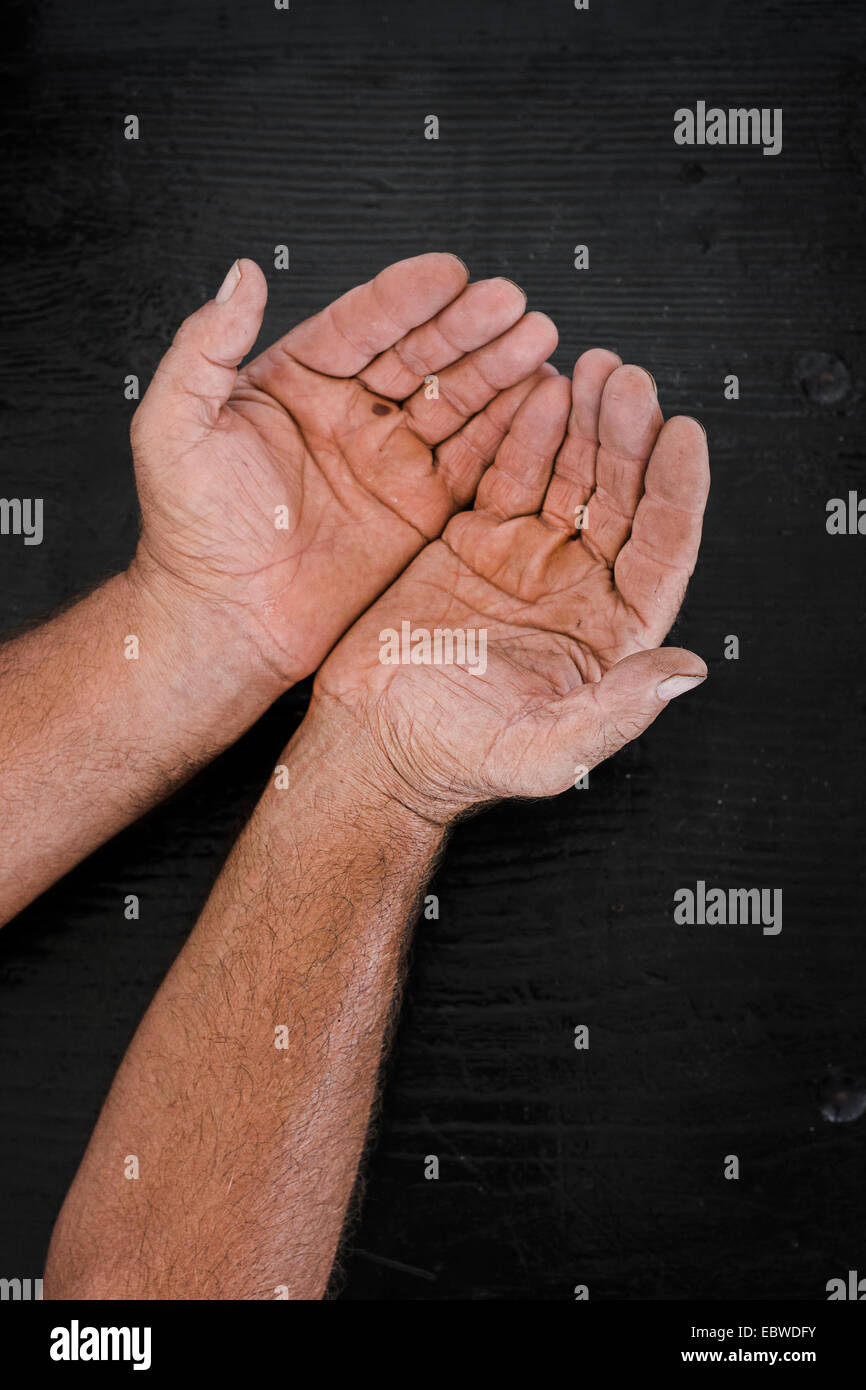 Farmer's hands joined like offering. Top view Stock Photo - Alamy