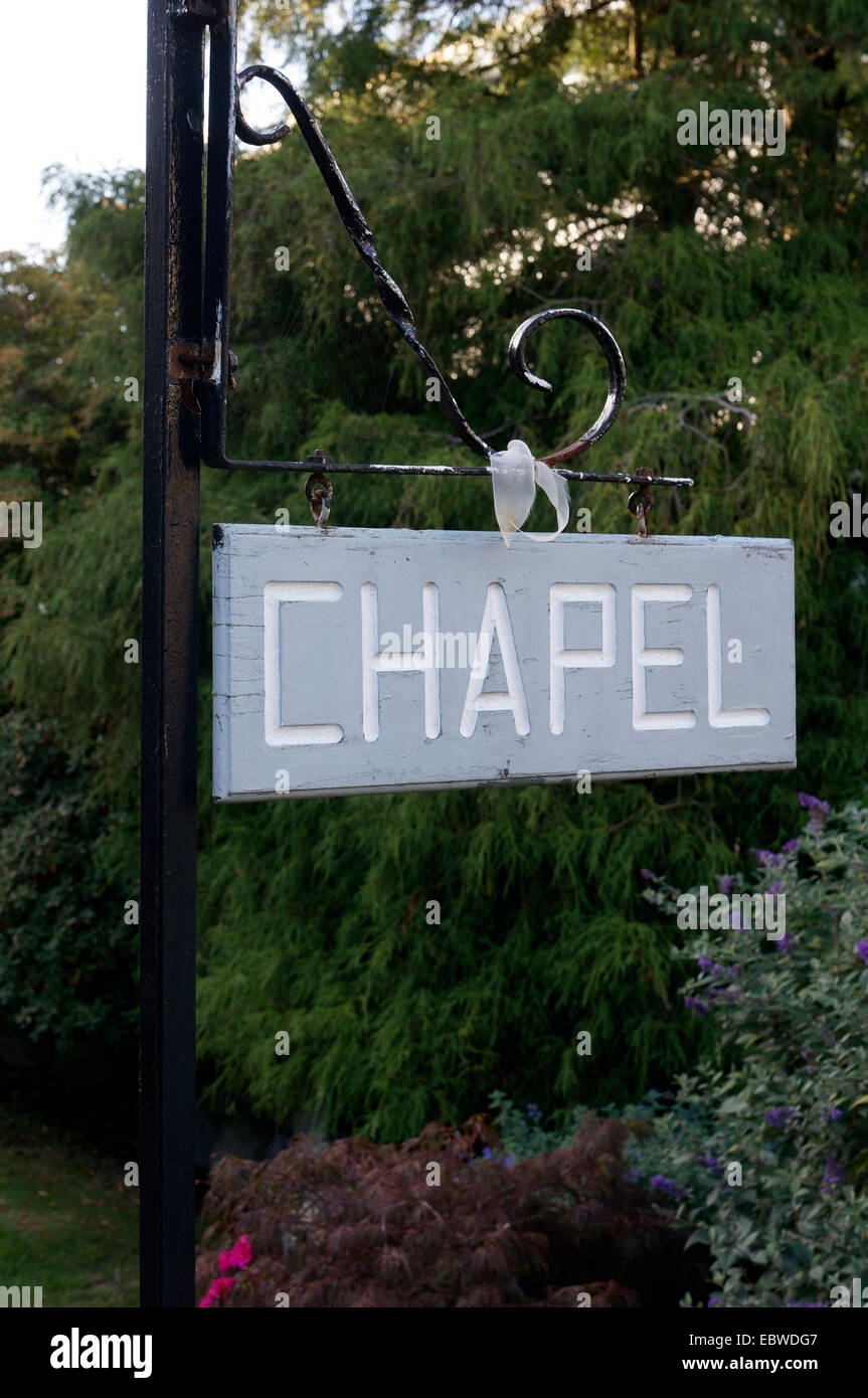 Chapel sign hanging from a black wrought iron post Stock Photo - Alamy