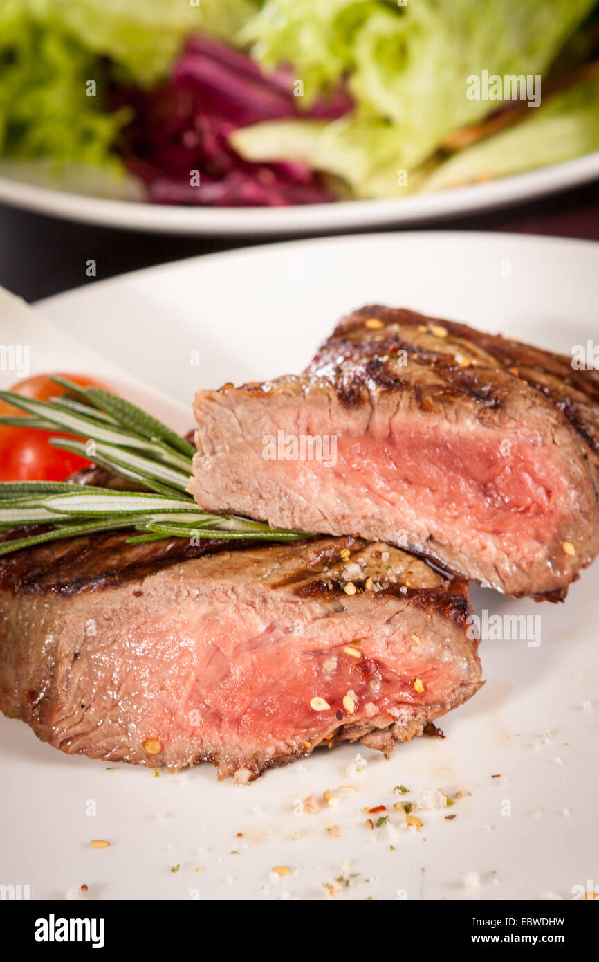 Succulent medium rare beef steak sliced through to display the tender ...