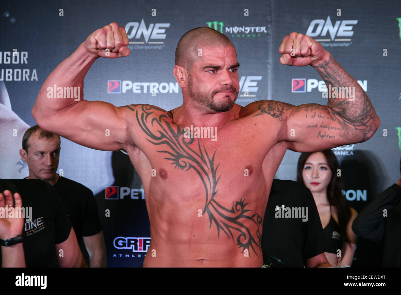 James McSweeny of the U.K. shows off his muscles during the OneFC weigh ...