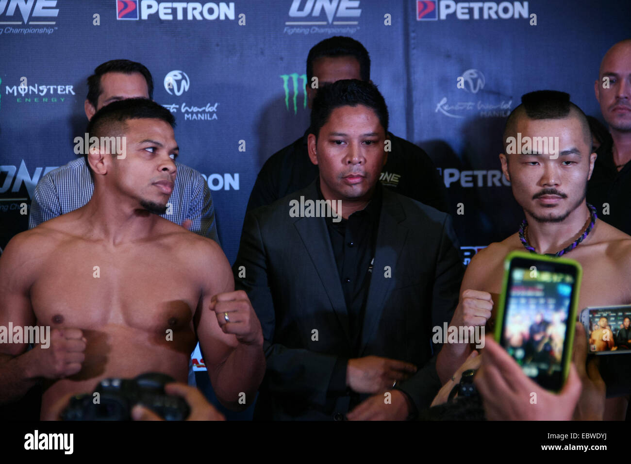 OneFC Bantamweight champion Bibiano Fernandes (L) of Brazil looks at ...