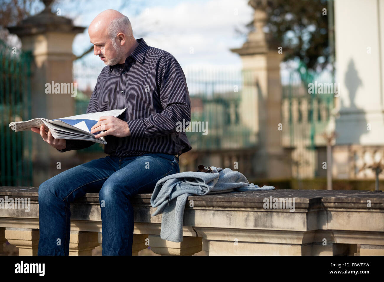 Confident attractive middle-aged man standing waiting in a rural lane ...