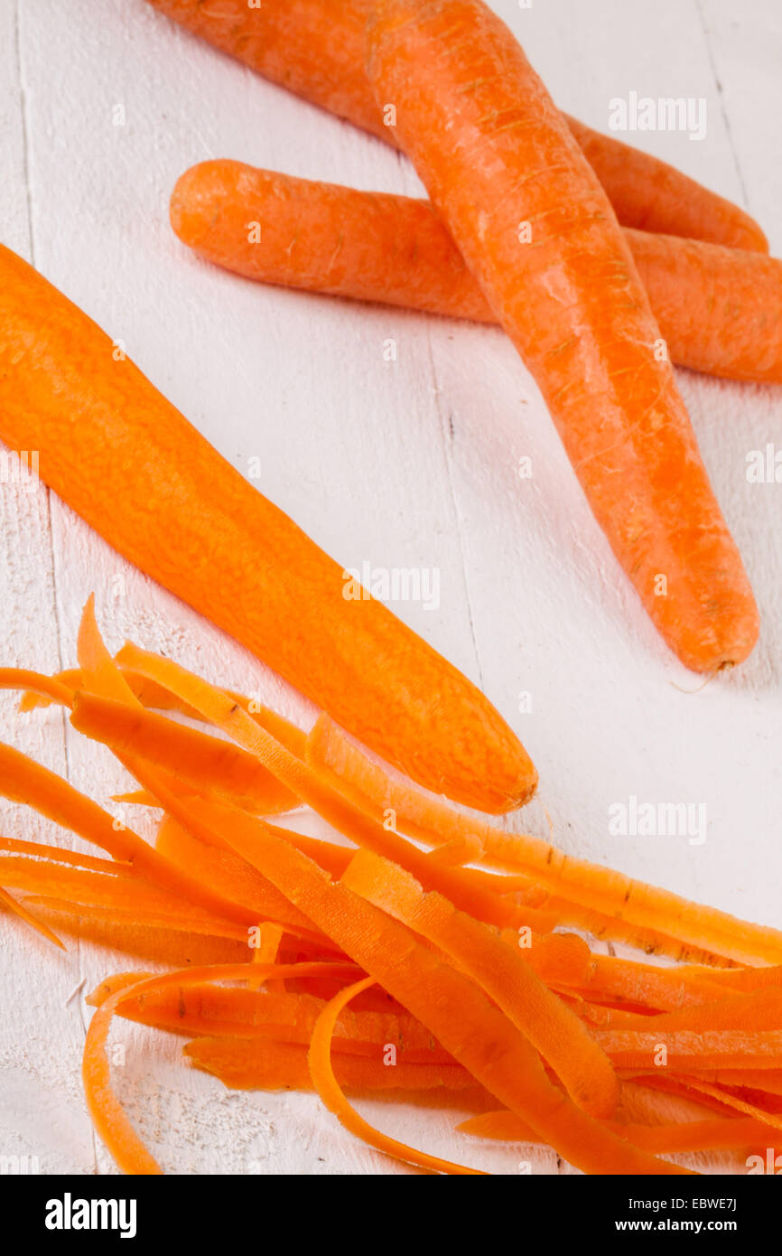Fresh peeled carrots sliced into thin batons for carrot julienne with a ...