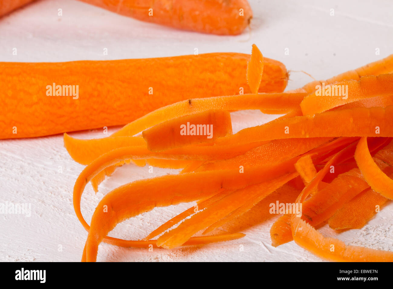 Fresh peeled carrots sliced into thin batons for carrot julienne with a ...