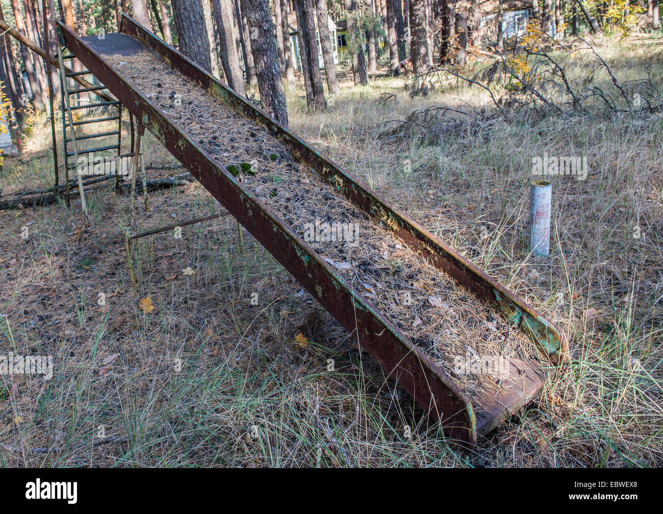 Rusty slide in holiday summer resort "Izumrudnoe" ("Emerald") between ...