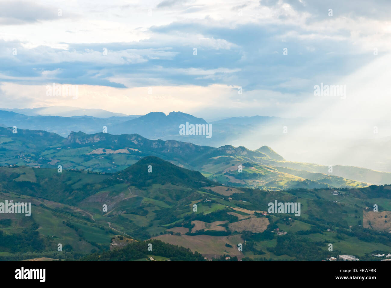 Sun rays shining down on hills in San Marino Stock Photo - Alamy