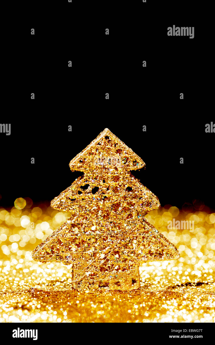 Beautiful golden decorative christmas tree on golden glitter background ...