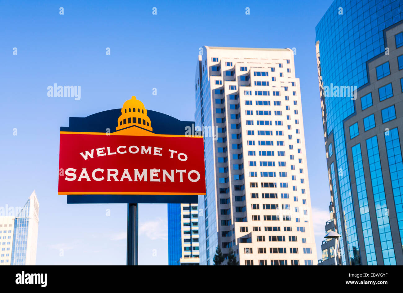 A 'Welcome to Sacramento' sign in downtown Sacramento, with skyscrapers ...