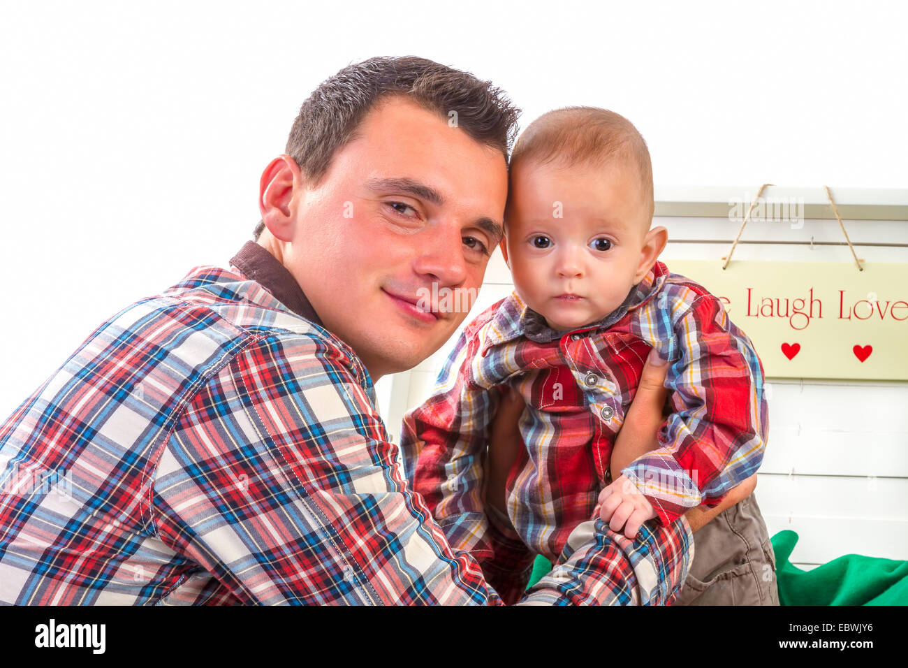 Baby boy with his father on white background Stock Photo - Alamy