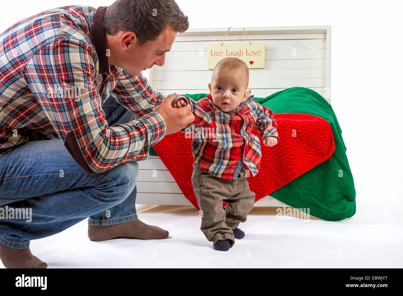 Baby boy with his father on white background Stock Photo - Alamy