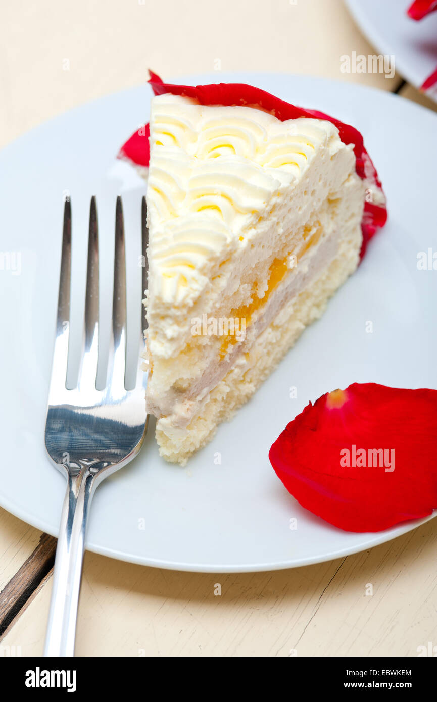 whipped cream mango cake with red rose petals Stock Photo - Alamy