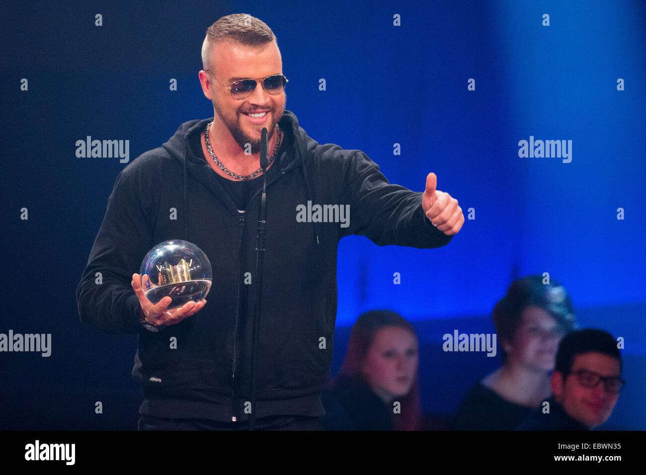 Bochum, Germany. 4th Dec, 2014. Rapper Kollegah celebrates his award ...