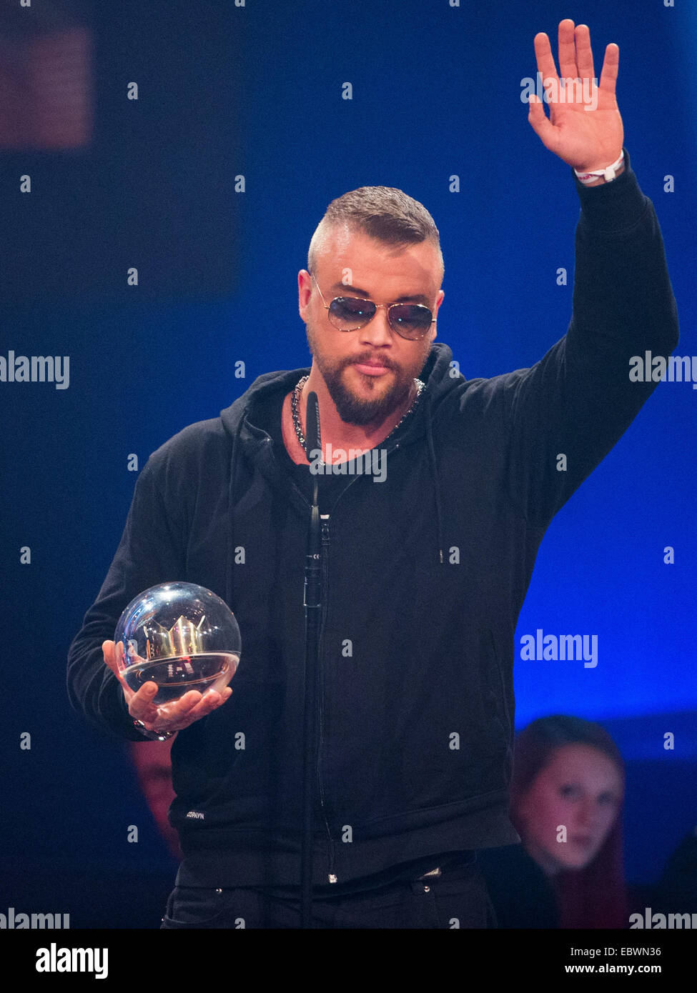 Bochum, Germany. 4th Dec, 2014. Rapper Kollegah celebrates his award ...