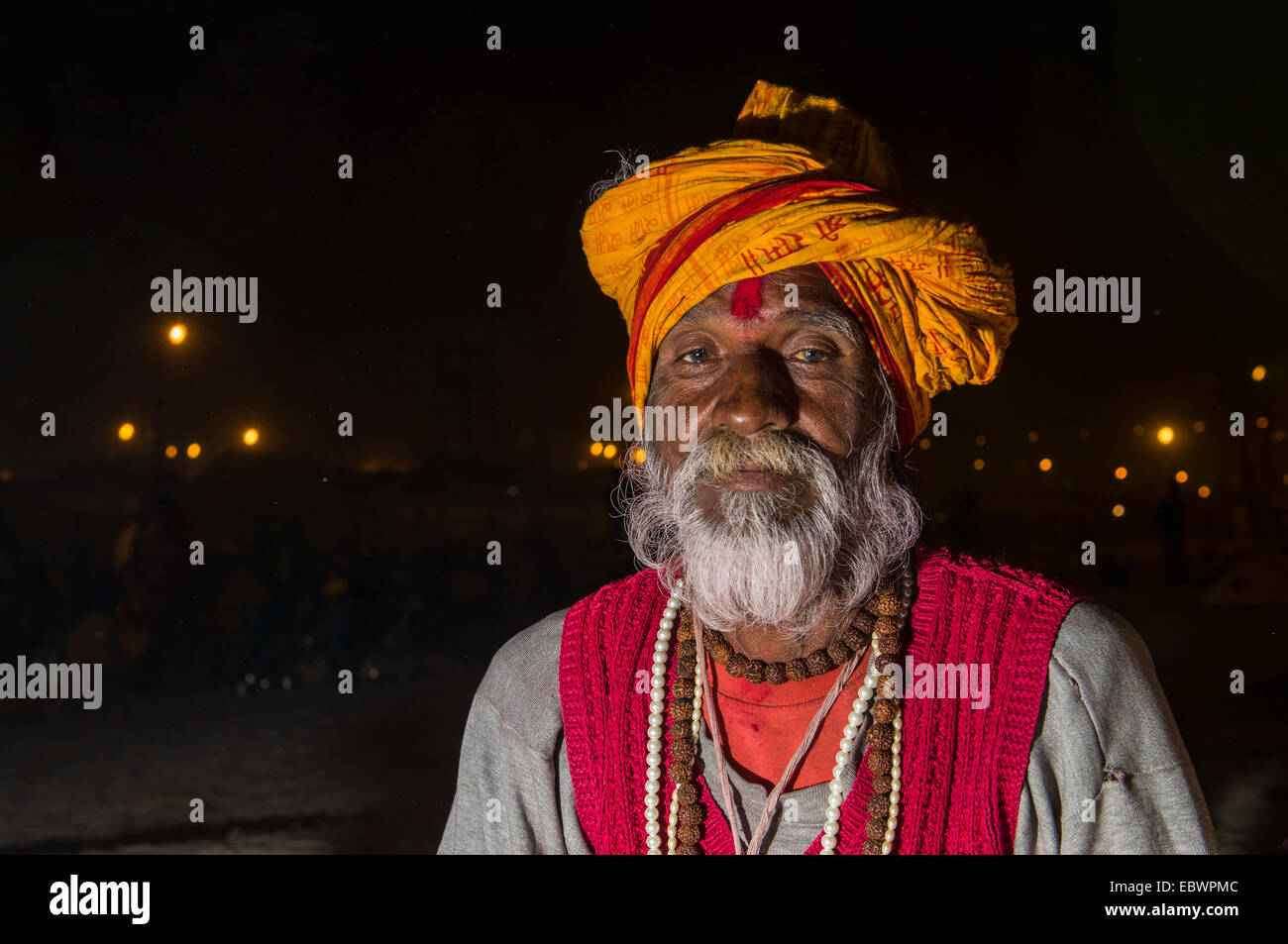 Portrait of a male pilgrim at night at the Sangam, the confluence of ...