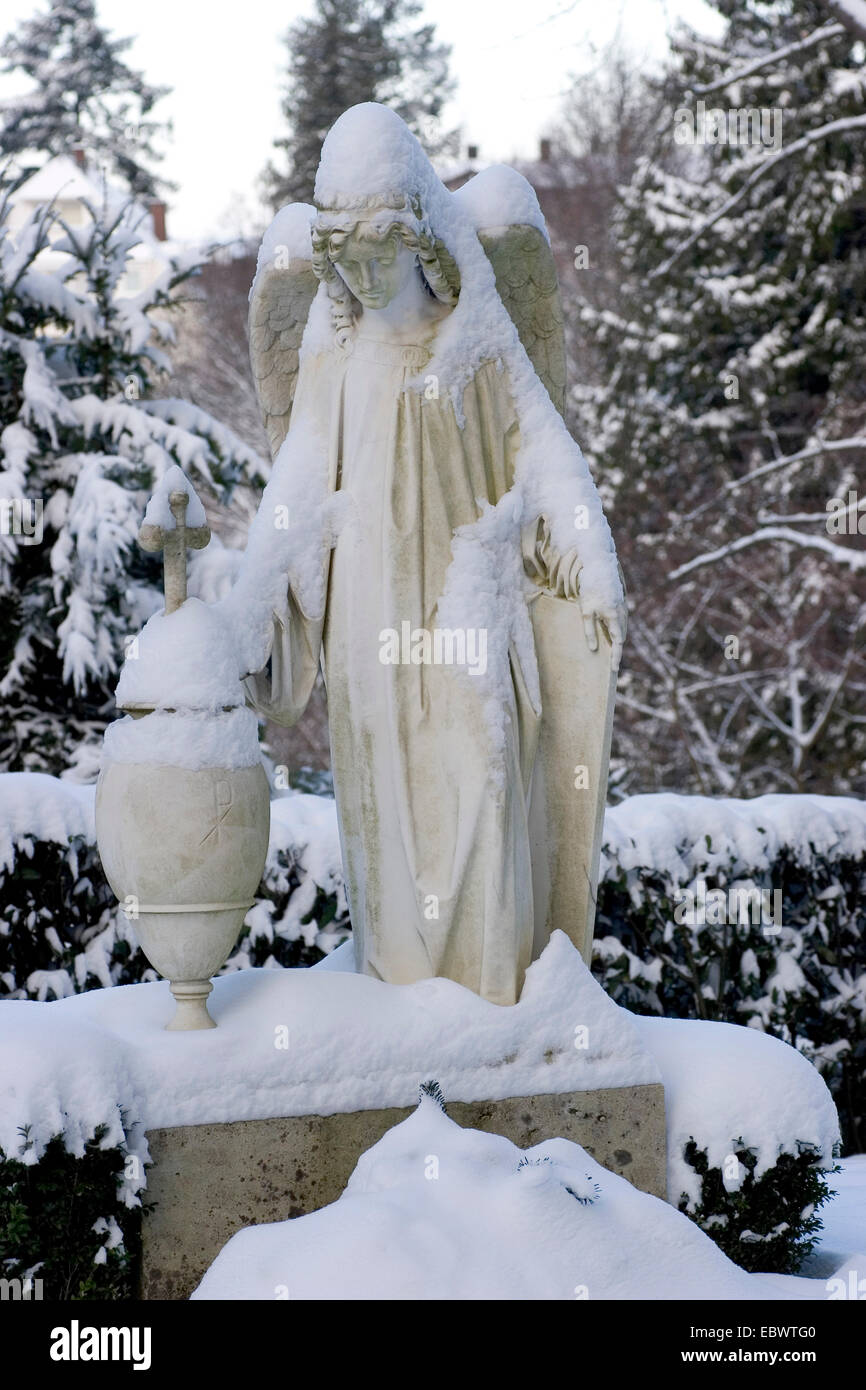 snow-covered angel statue on a cemetery, Germany, Baden-Wuerttemberg ...