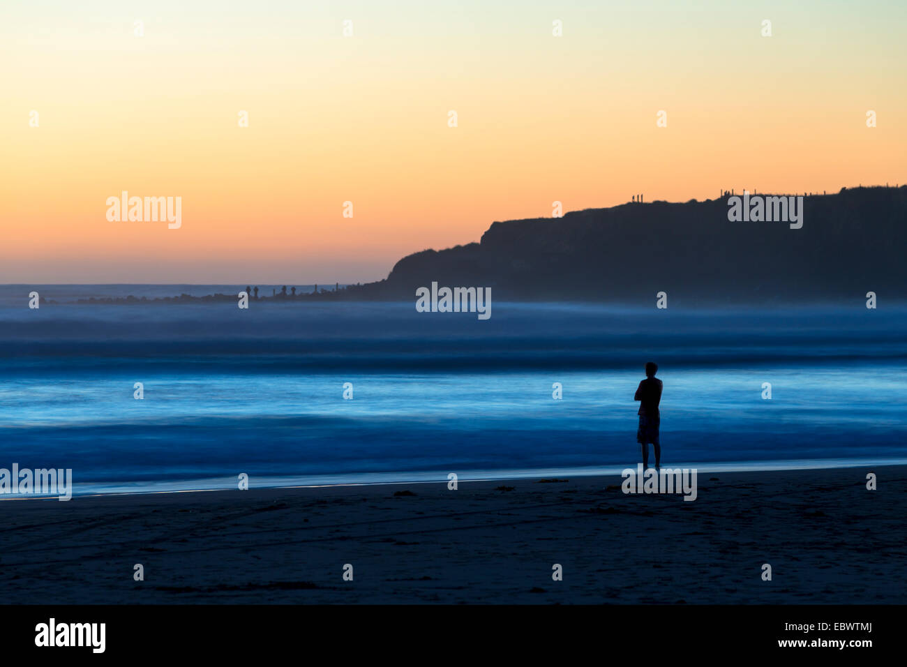 Man on the beach with surf, Opunake, Taranaki Region, New Zealand Stock ...