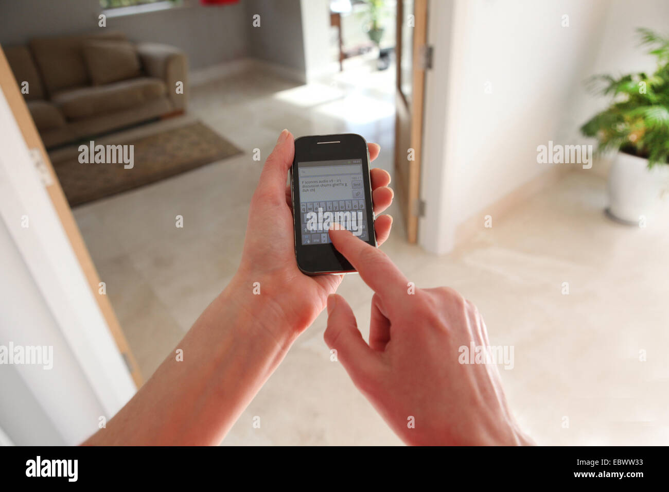 Girl using smart phone at home Stock Photo - Alamy