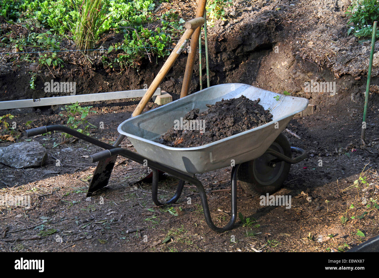 wheelbarrow with garden accessories, Germany Stock Photo - Alamy