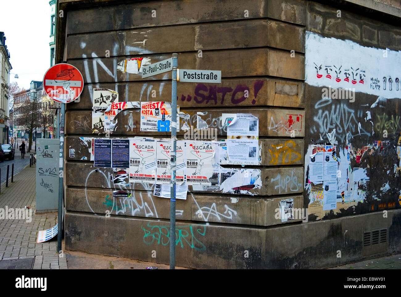 graffitis and remains of bills at a fassade at a street corner in the ...