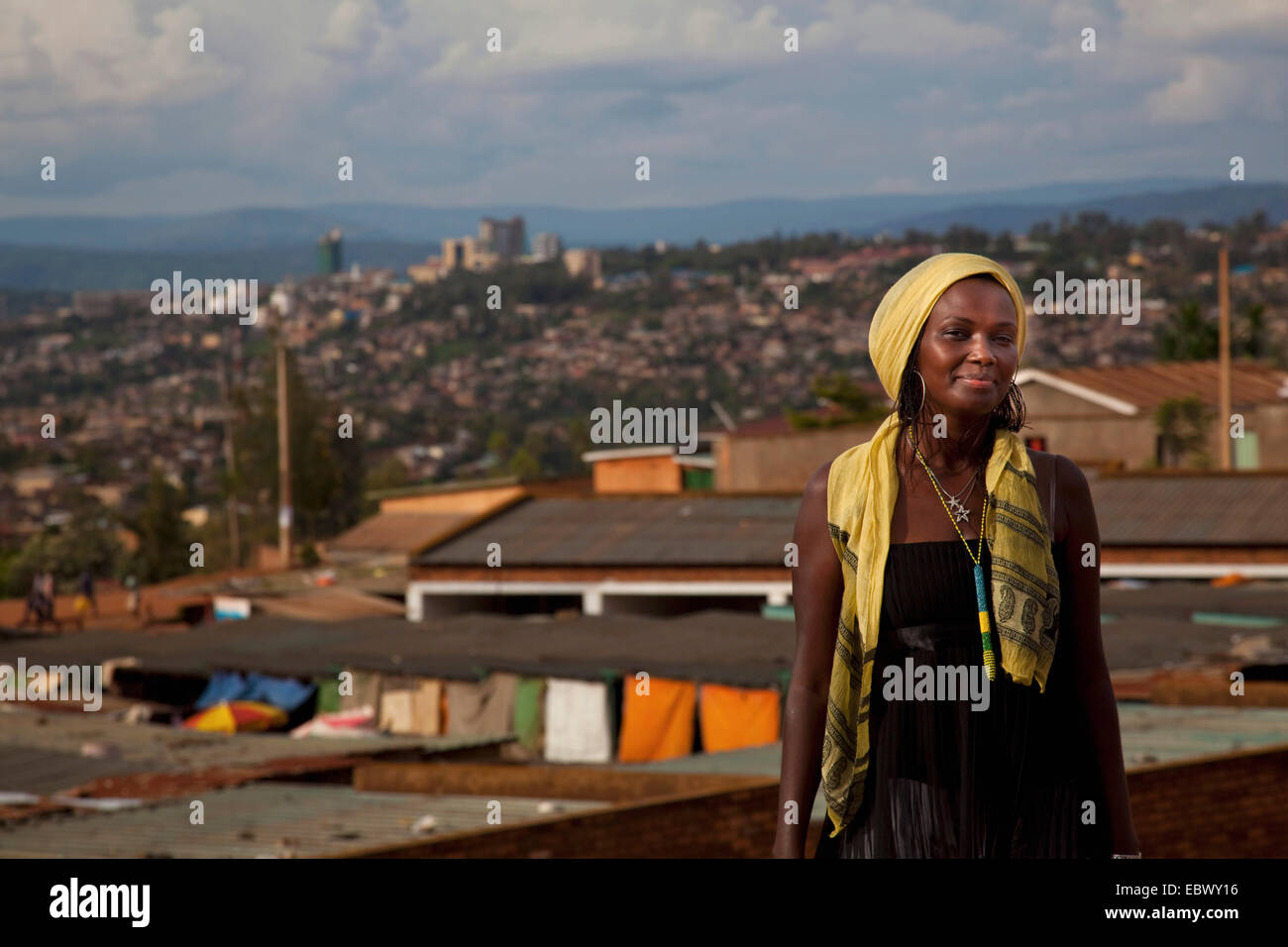 pretty young woman standing smiling in front city panorama with poorer ...