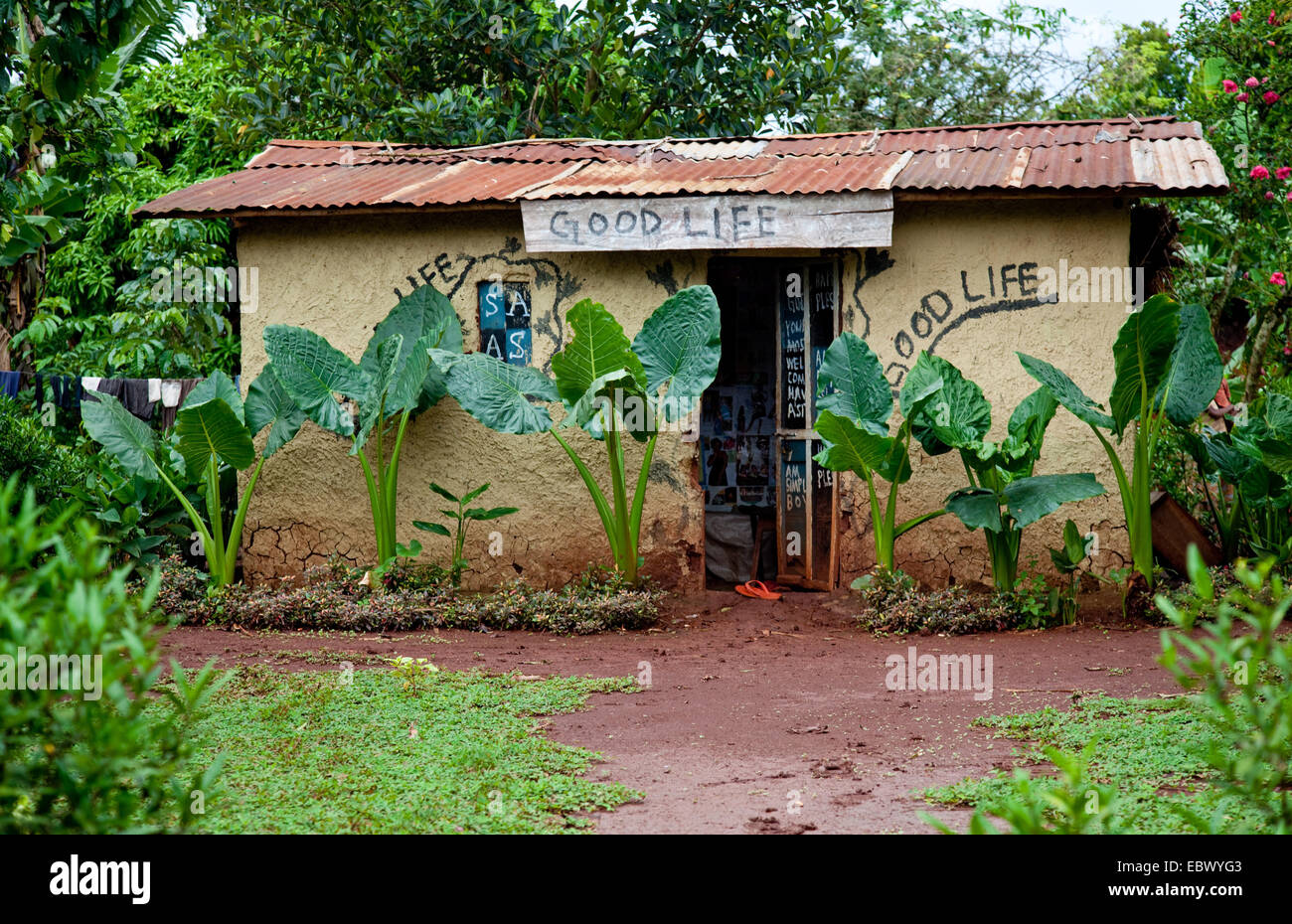 simple mud house in a poor area has been painted with the words 'good ...