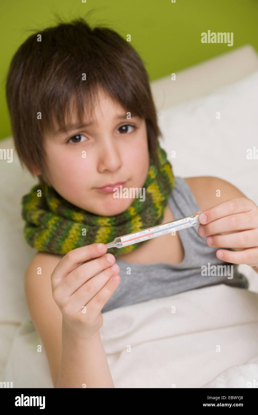 sick boy with fever in bed Stock Photo - Alamy