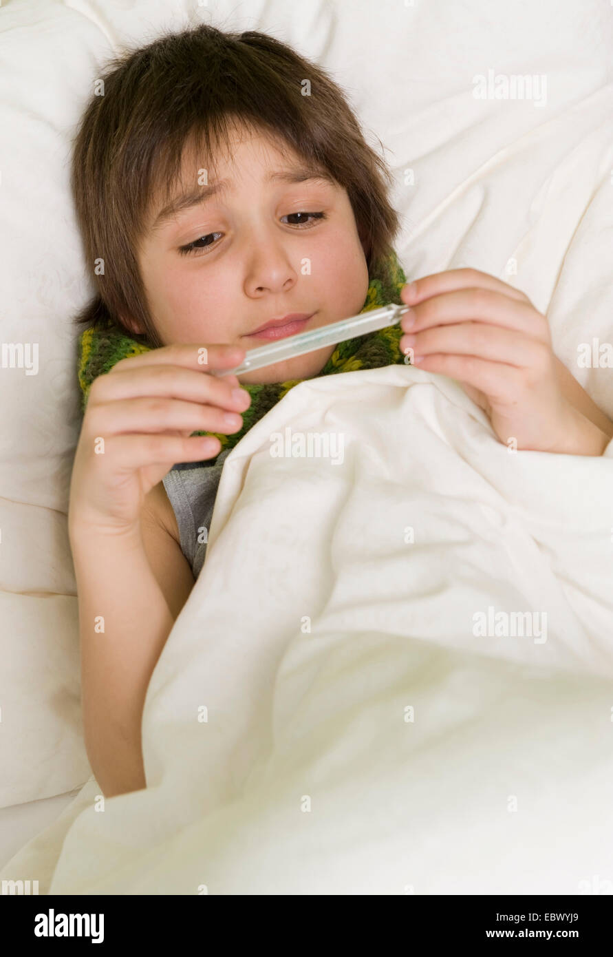 sick boy with fever in bed Stock Photo - Alamy
