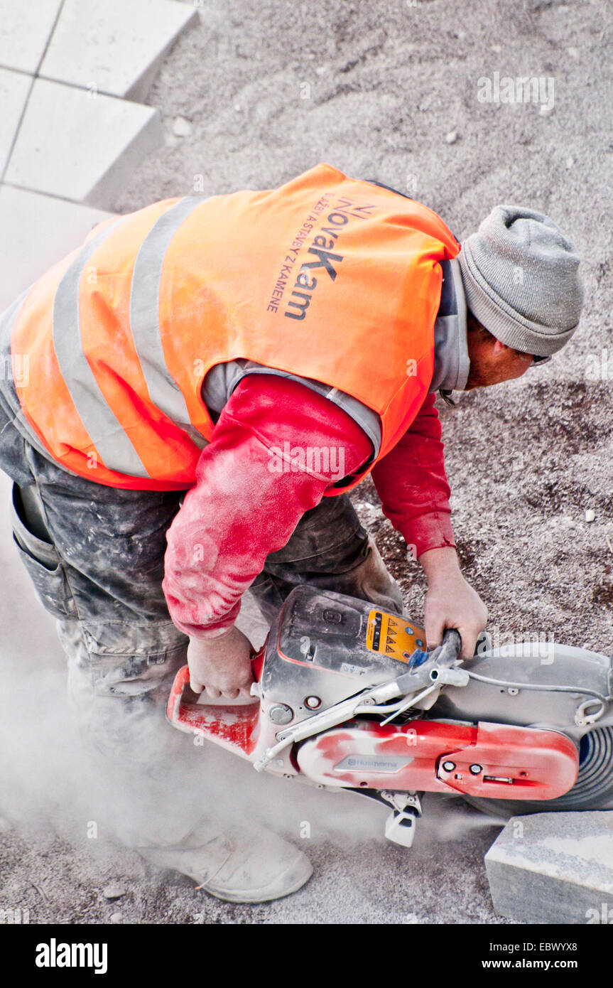 construction worker stone cutting work by cut-off saw with diamond ...