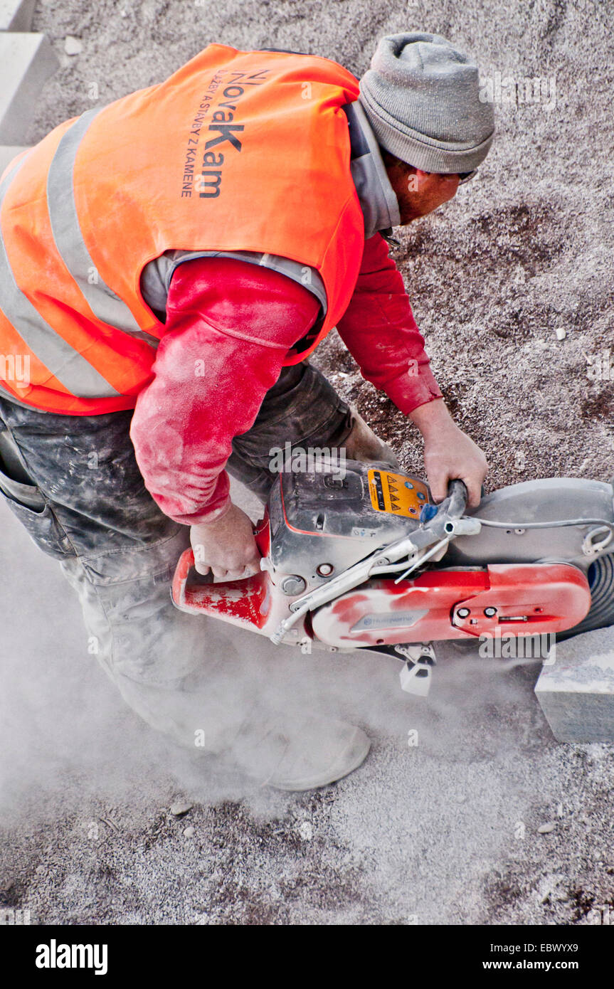construction worker stone cutting work by cut-off saw with diamond ...
