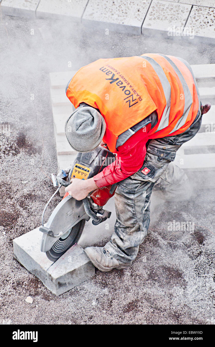 construction worker stone cutting work by cut-off saw with diamond ...