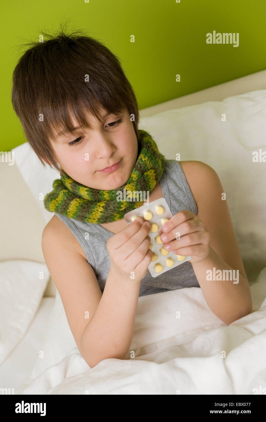 sick boy takes tablets Stock Photo - Alamy
