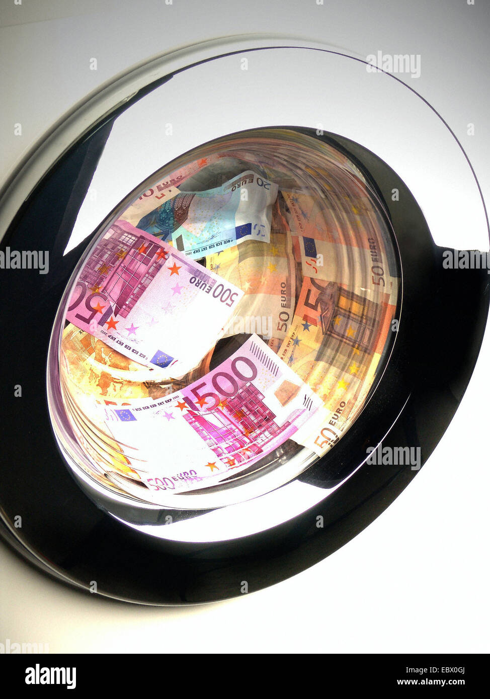 symbolic picture money laundering, bank notes in a washing machine ...