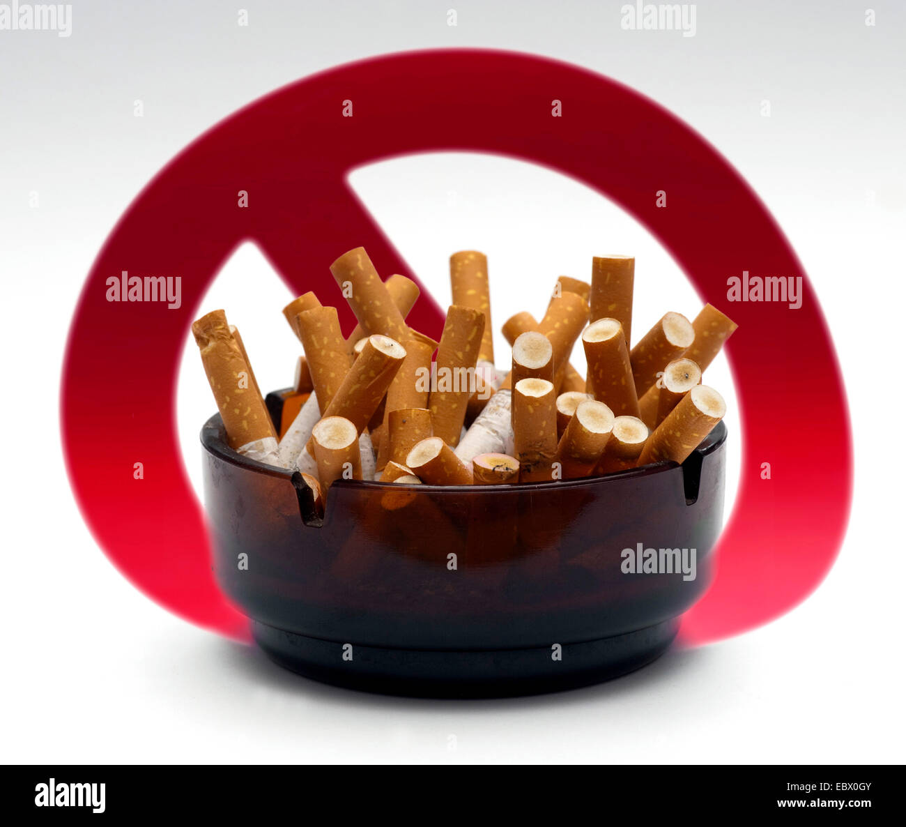 full ash tray in front of an prohited sign Stock Photo - Alamy