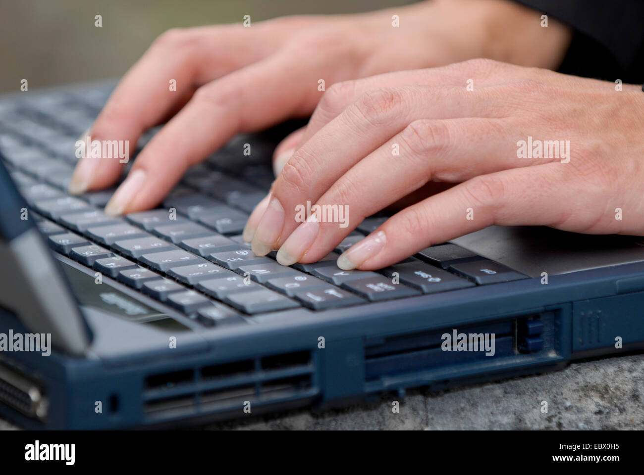 woman's hands typing on a laptop keypad Stock Photo - Alamy