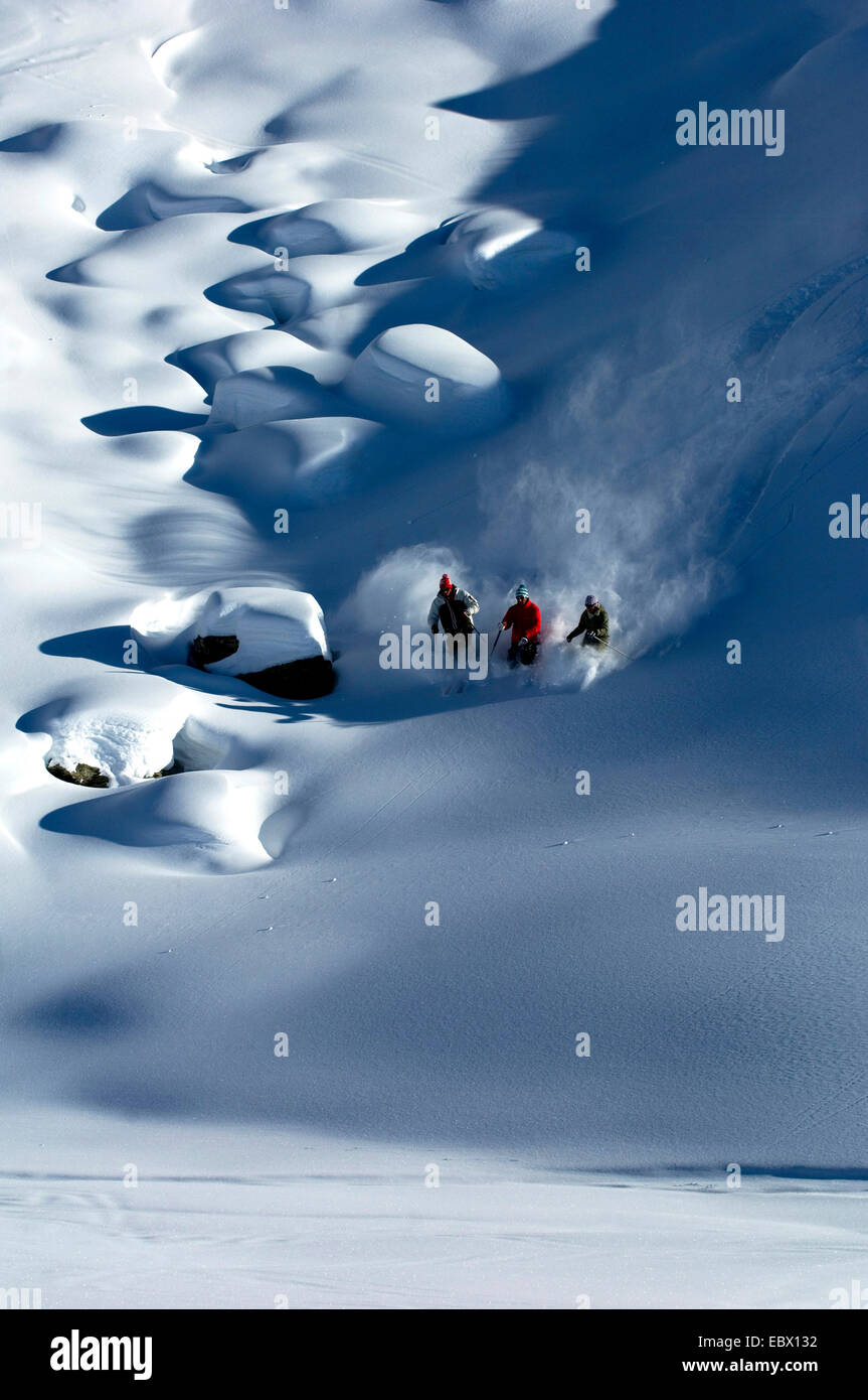 three skier deep powder snow skiing, France Stock Photo - Alamy
