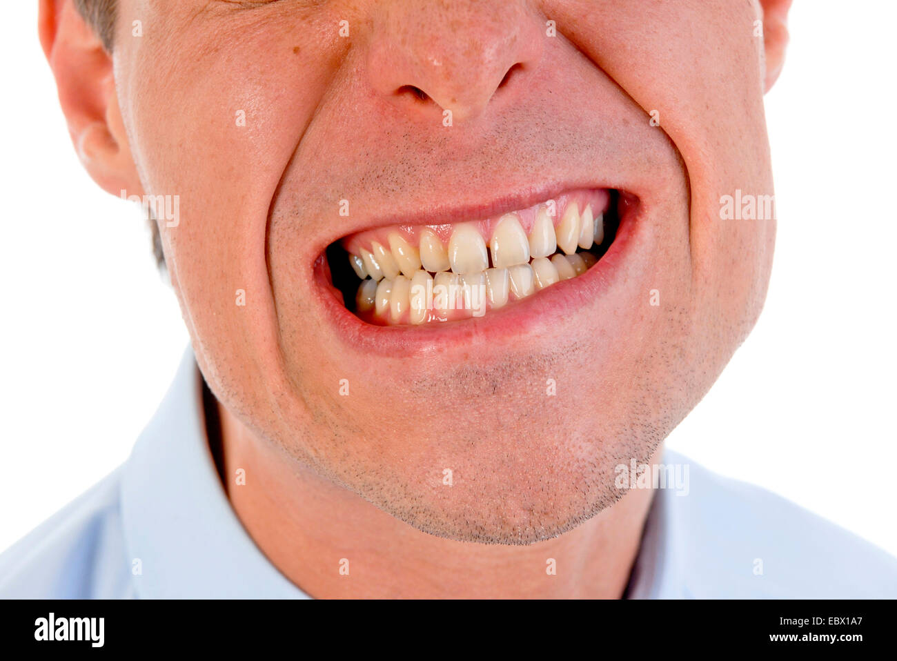 young man showing teeth Stock Photo - Alamy