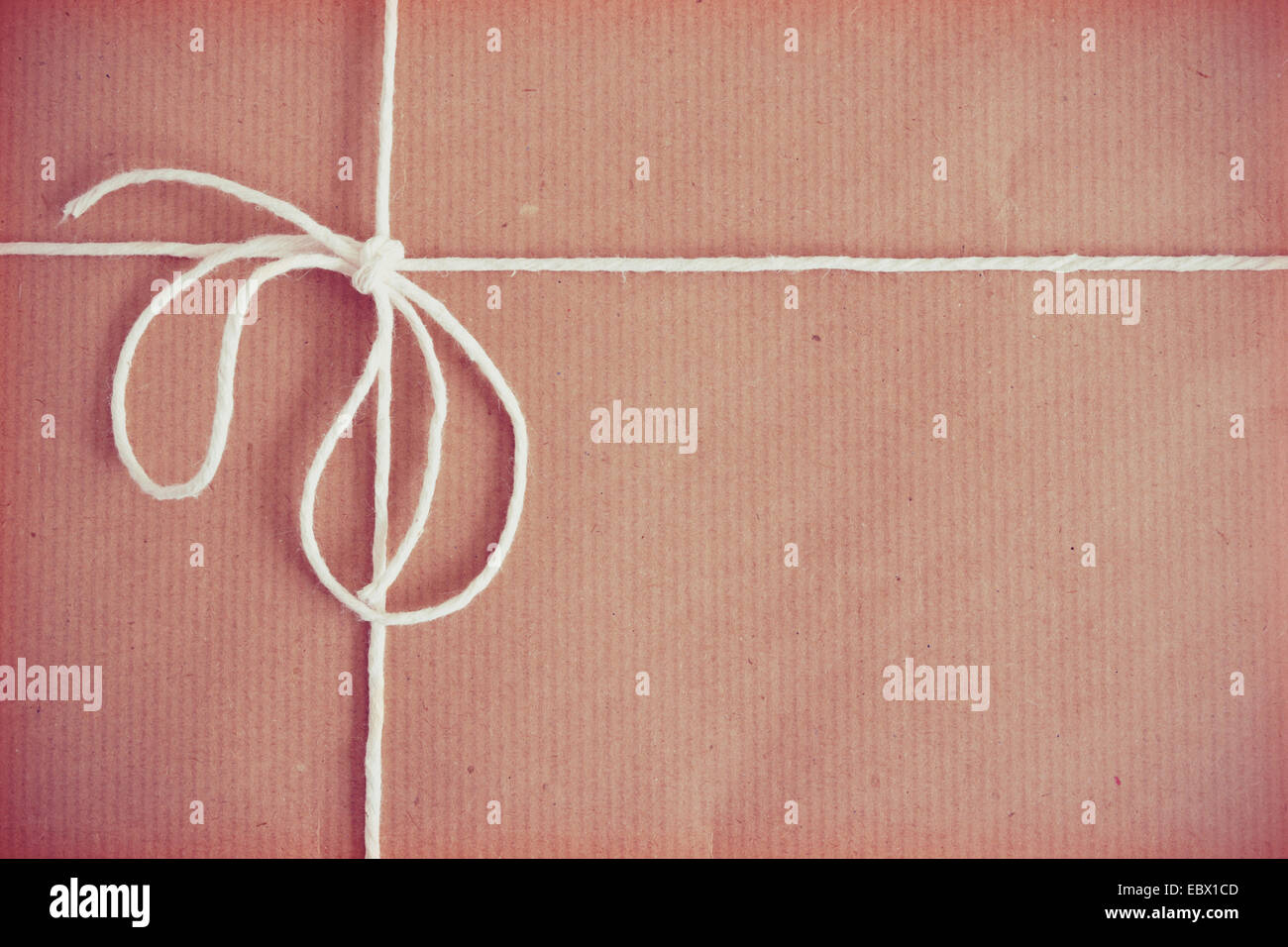 Vintage effect parcel wrapping paper tied with string Stock Photo - Alamy