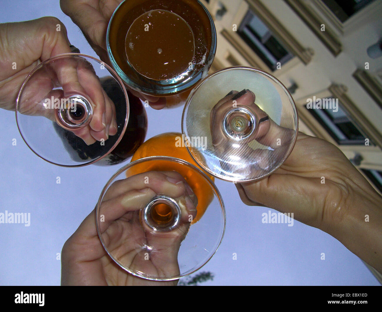 four persons clinking glasses, view from above Stock Photo - Alamy