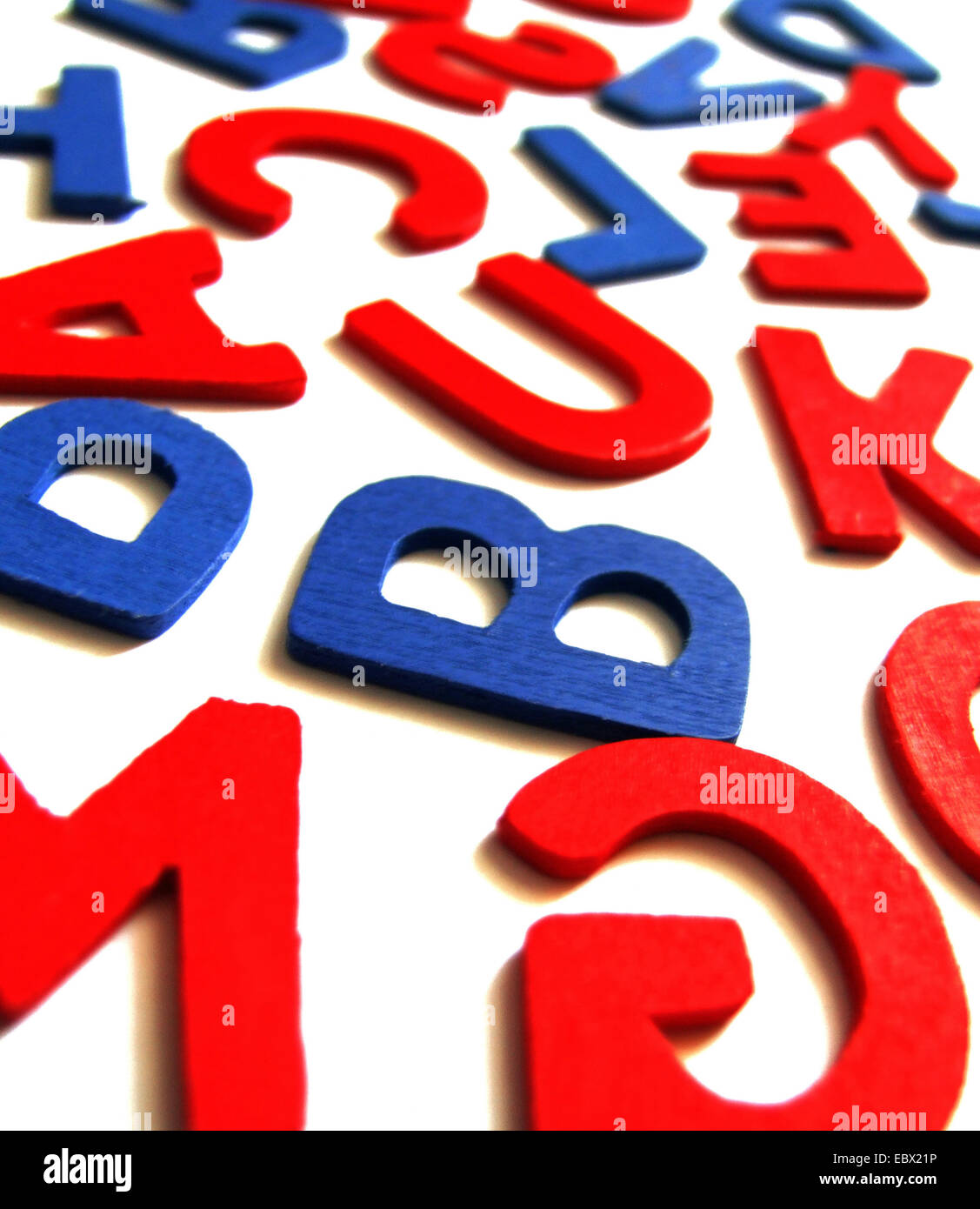 red and blue wooden letters spread on white ground Stock Photo - Alamy