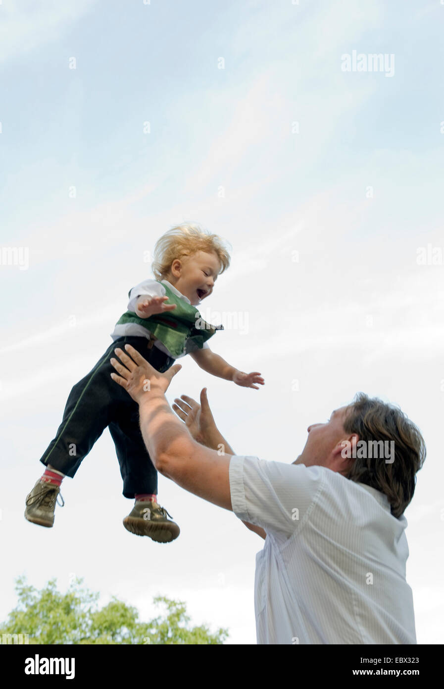 father throws sun in the sky Stock Photo - Alamy