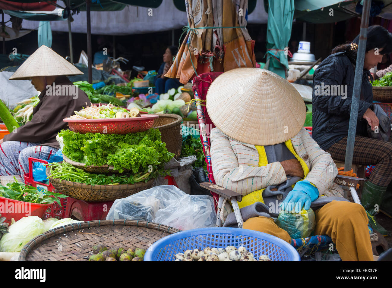 Sleeping female market trader at a local market in Vietnam Stock Photo ...