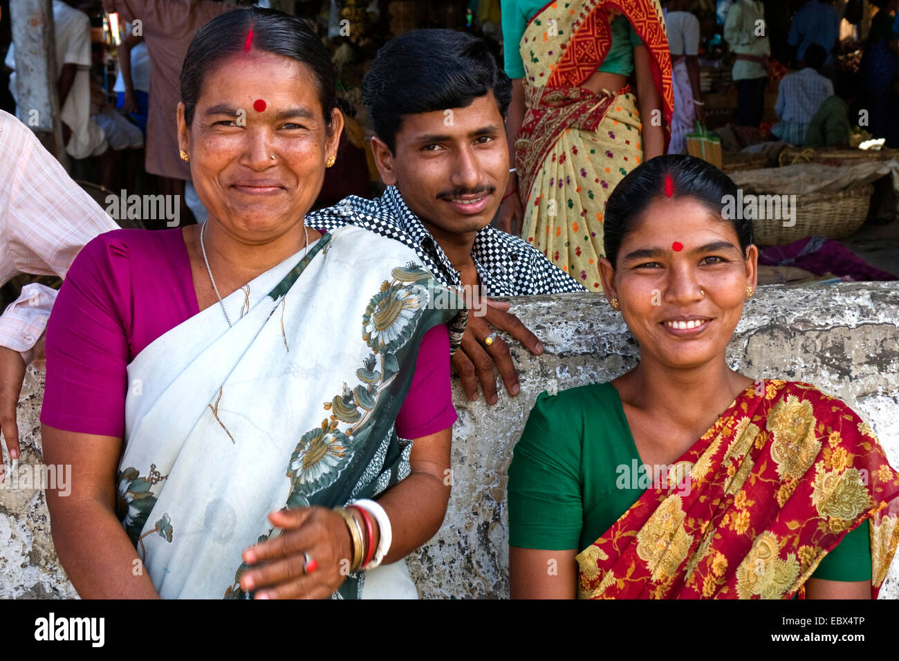 two female Indian in traditional clothing with a market trader, India ...
