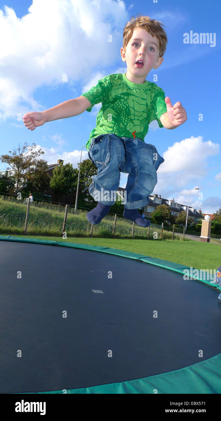 little boy jumping on a trampoline Stock Photo - Alamy