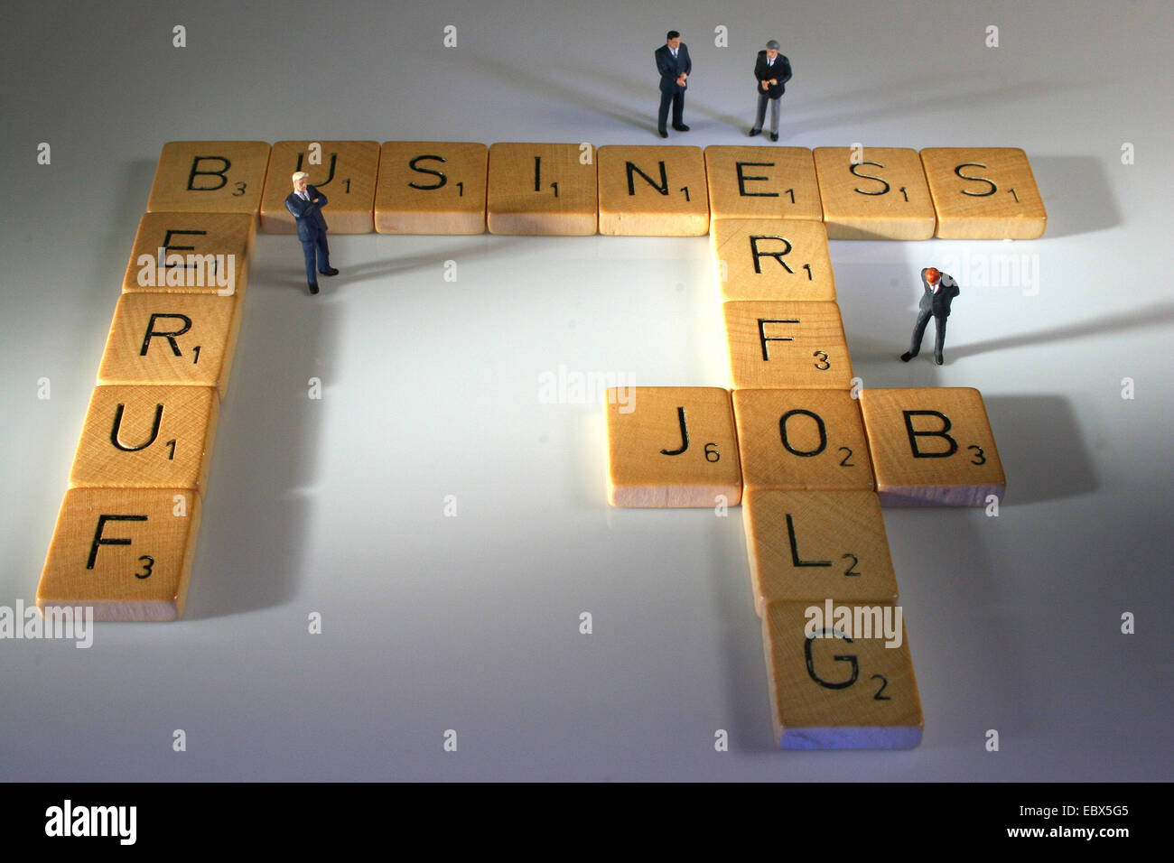 scrabble and figures of businessmen Stock Photo - Alamy