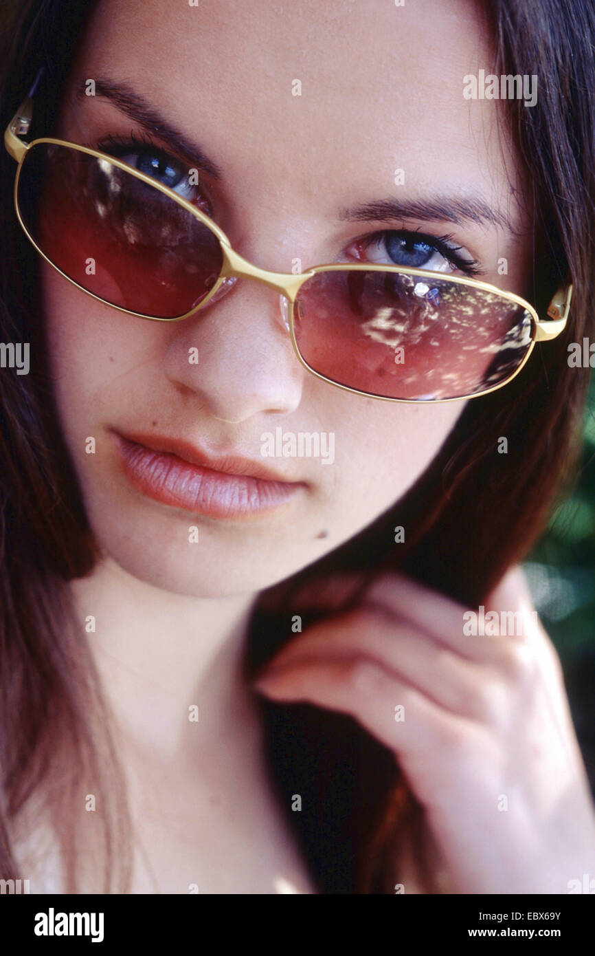 portrait of a brunette young woman lasciviously looking over her ...