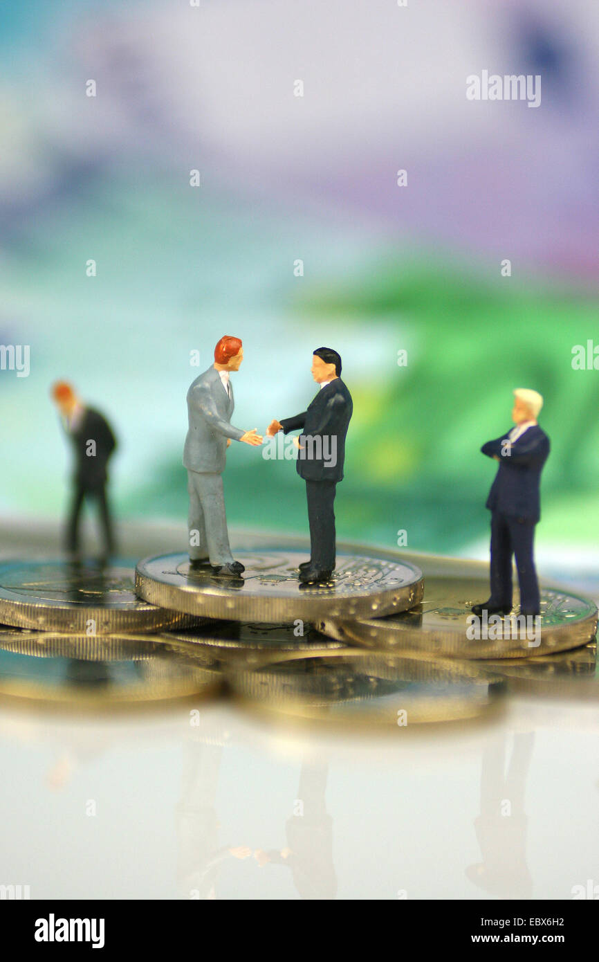 figures of business men standing on money Stock Photo - Alamy