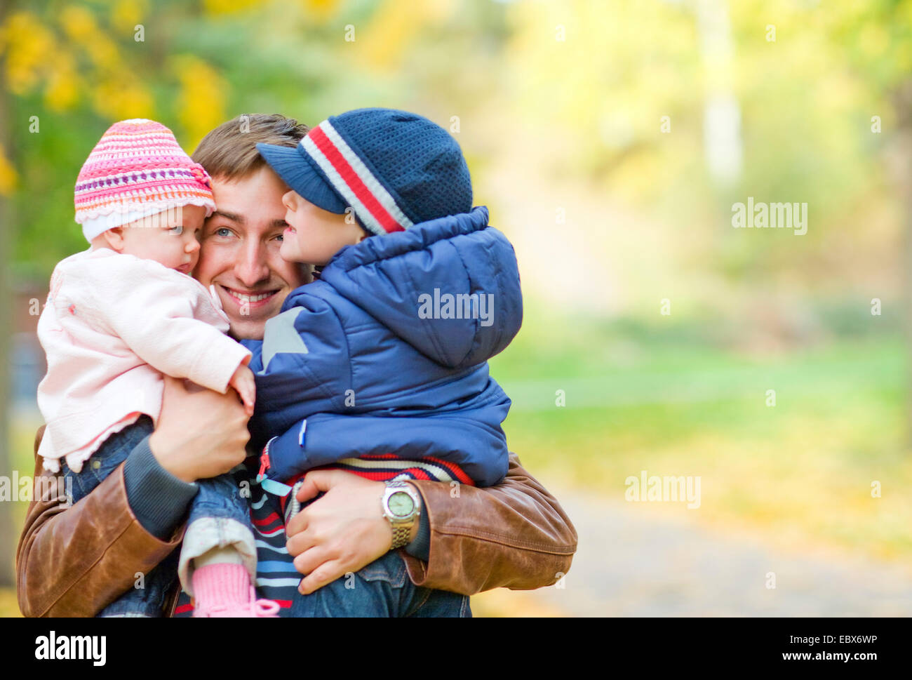 Young father with two kids enjoying beautiful autumn day Stock Photo ...