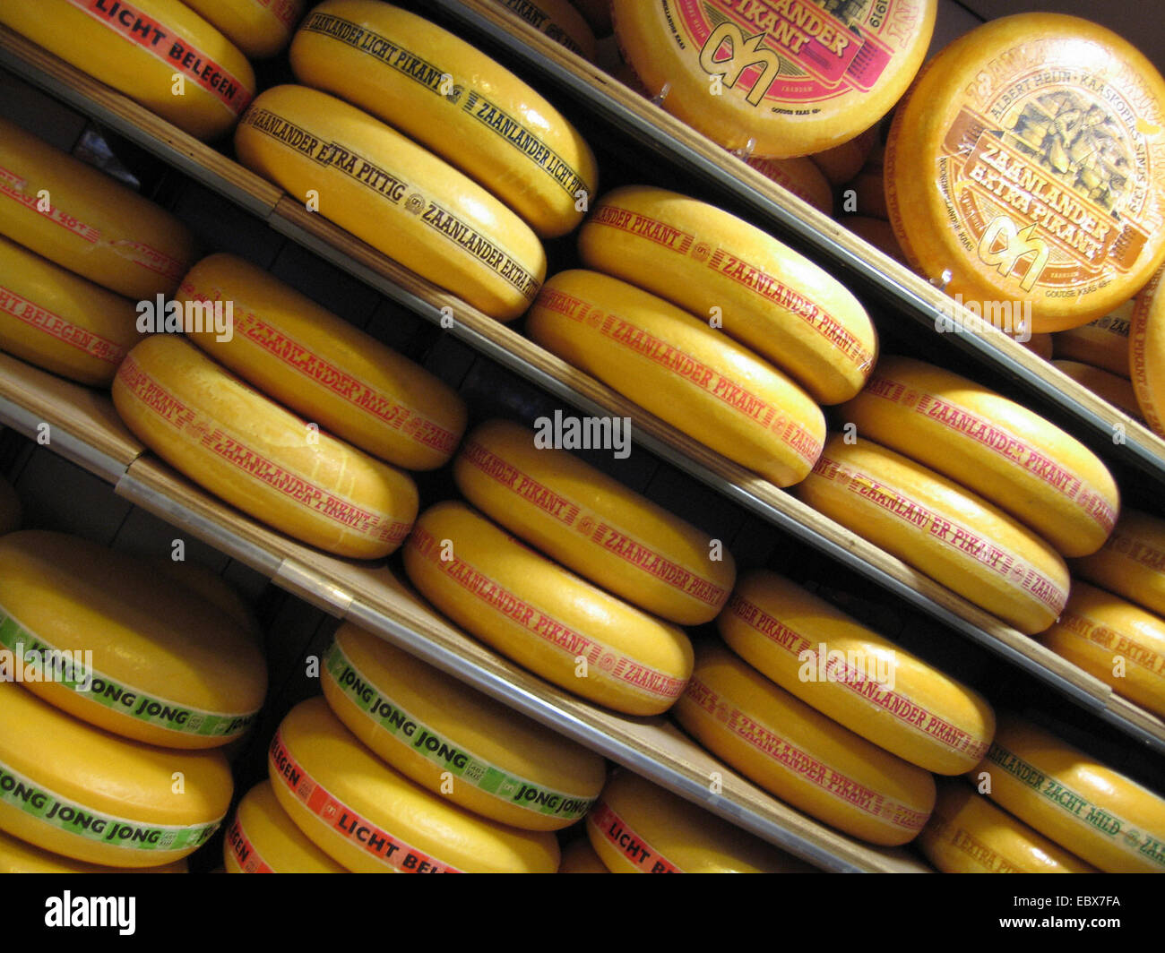cheese wheels in a storage rack Stock Photo - Alamy