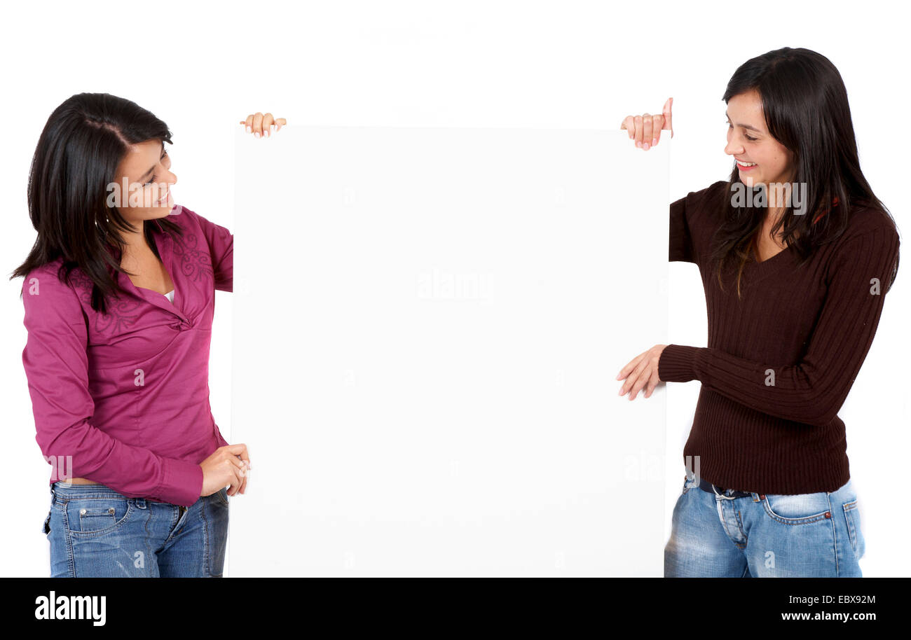 two women doing a presentation smiling Stock Photo - Alamy